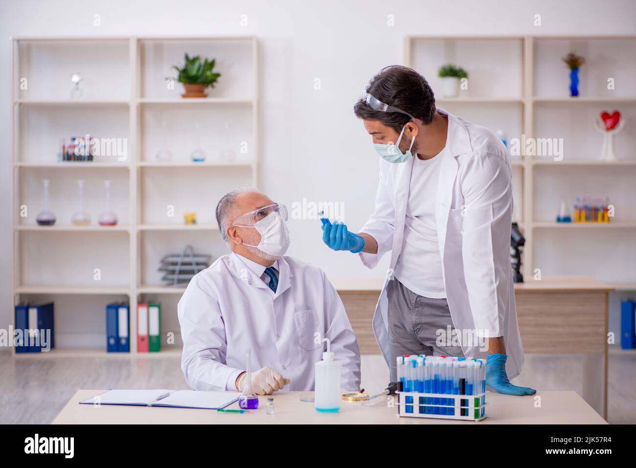 Two chemist working at the lab Stock Photo - Alamy