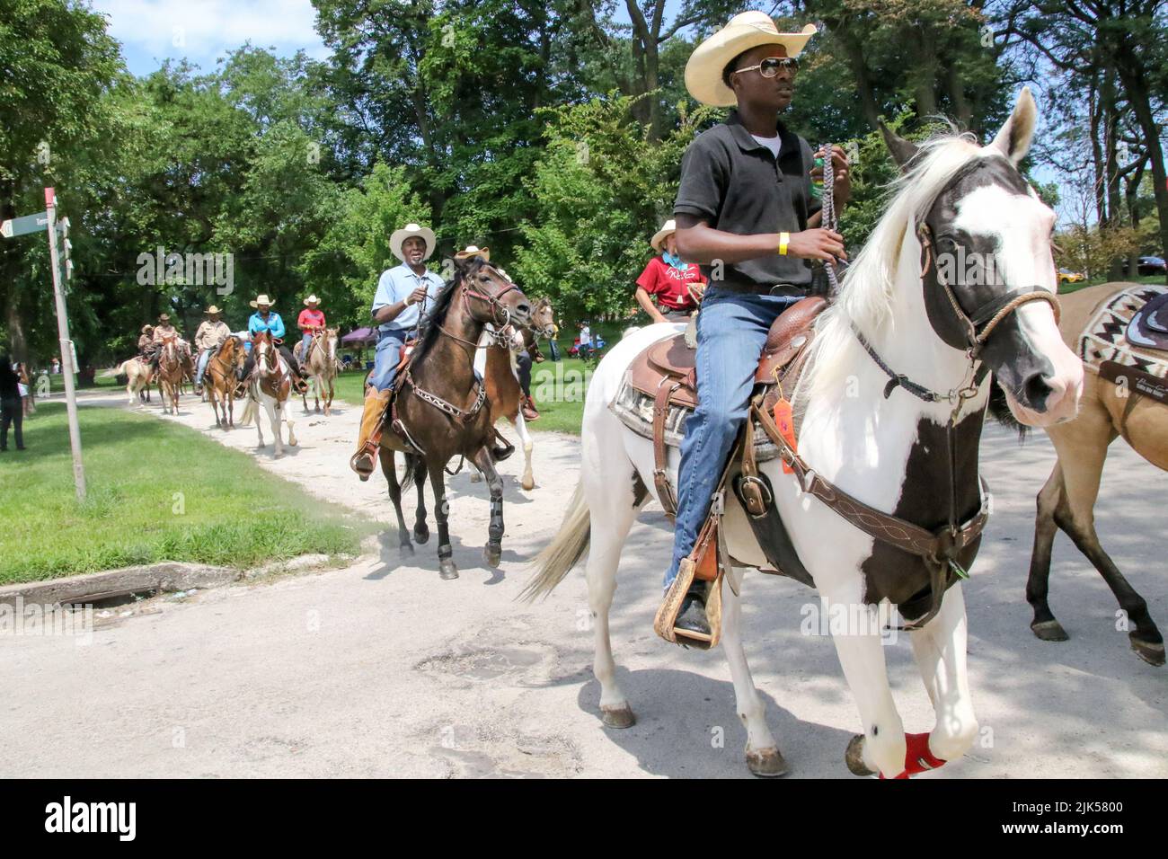 Riders and their horses participate in the group ride to the Lakefront ...