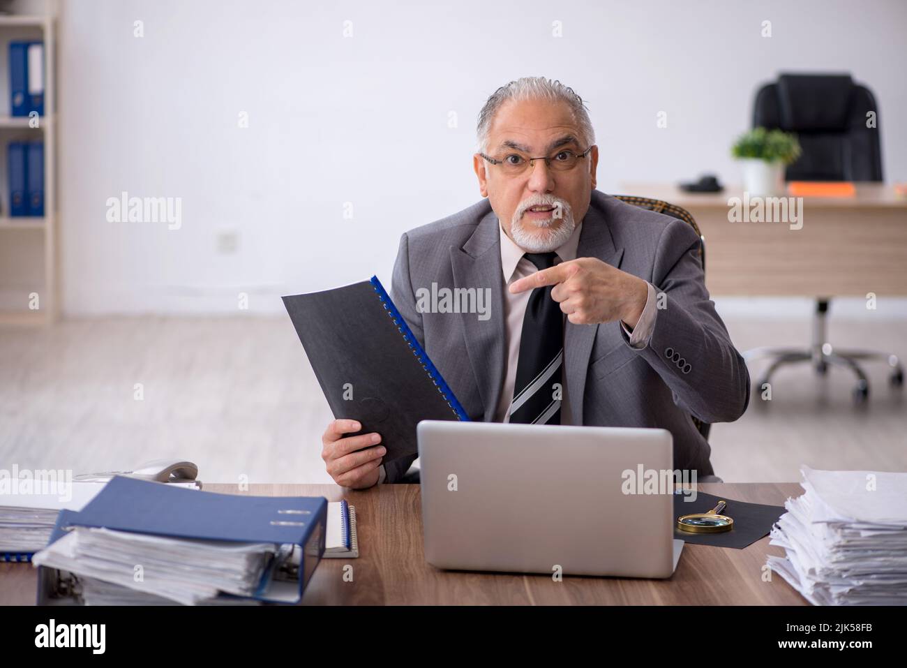 Old male boss sitting at workplace Stock Photo - Alamy