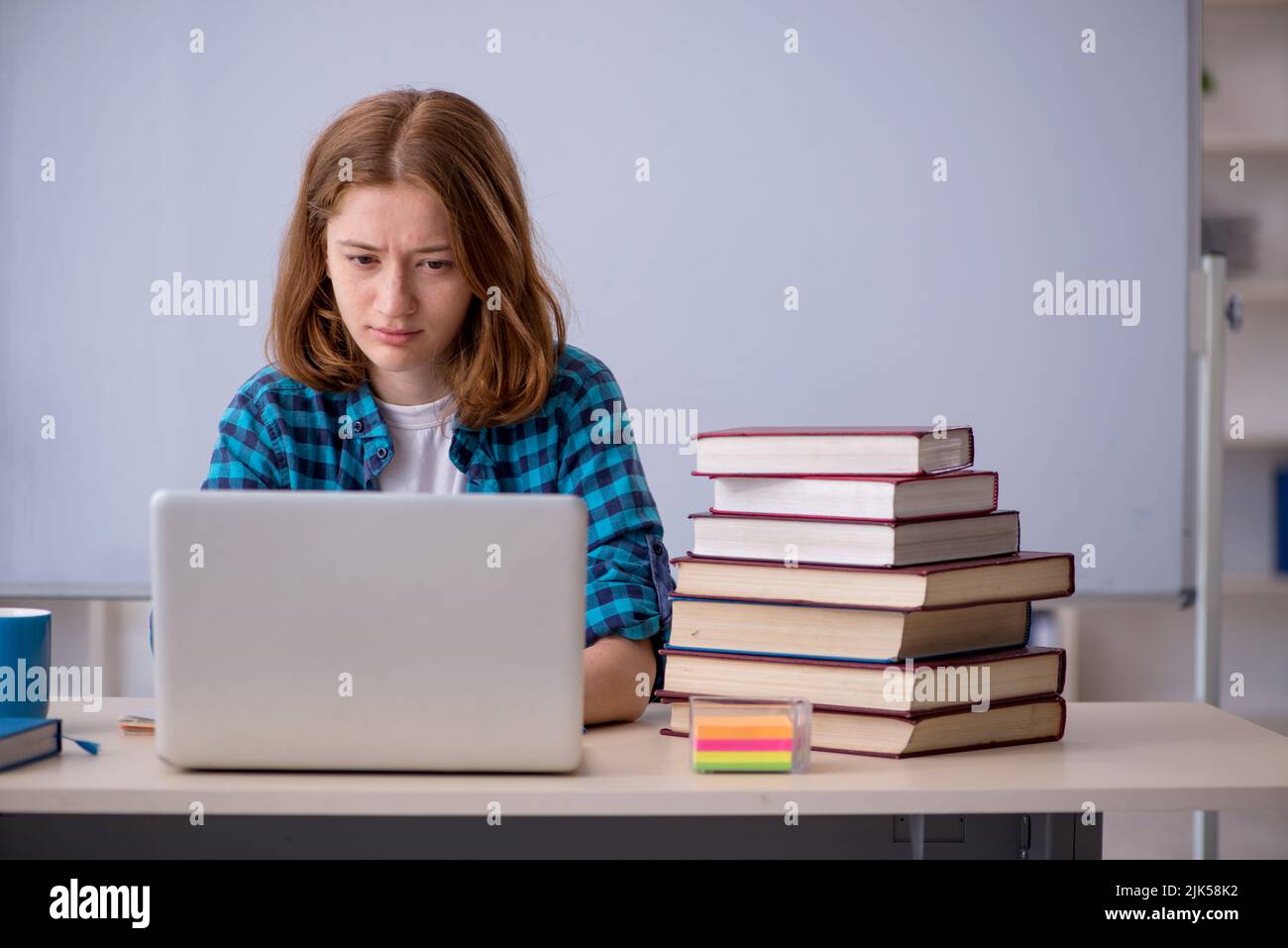 Young girl student preparing for exams in the classroom Stock Photo - Alamy