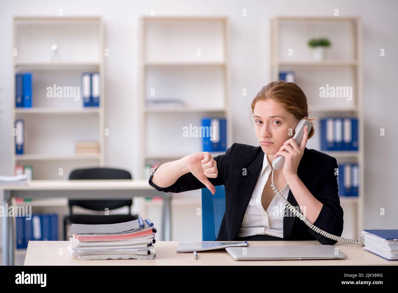 Female employee sitting at workplace Stock Photo - Alamy