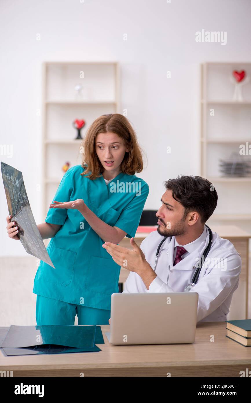 Young male doctor radiologist and female assistant working at the ...