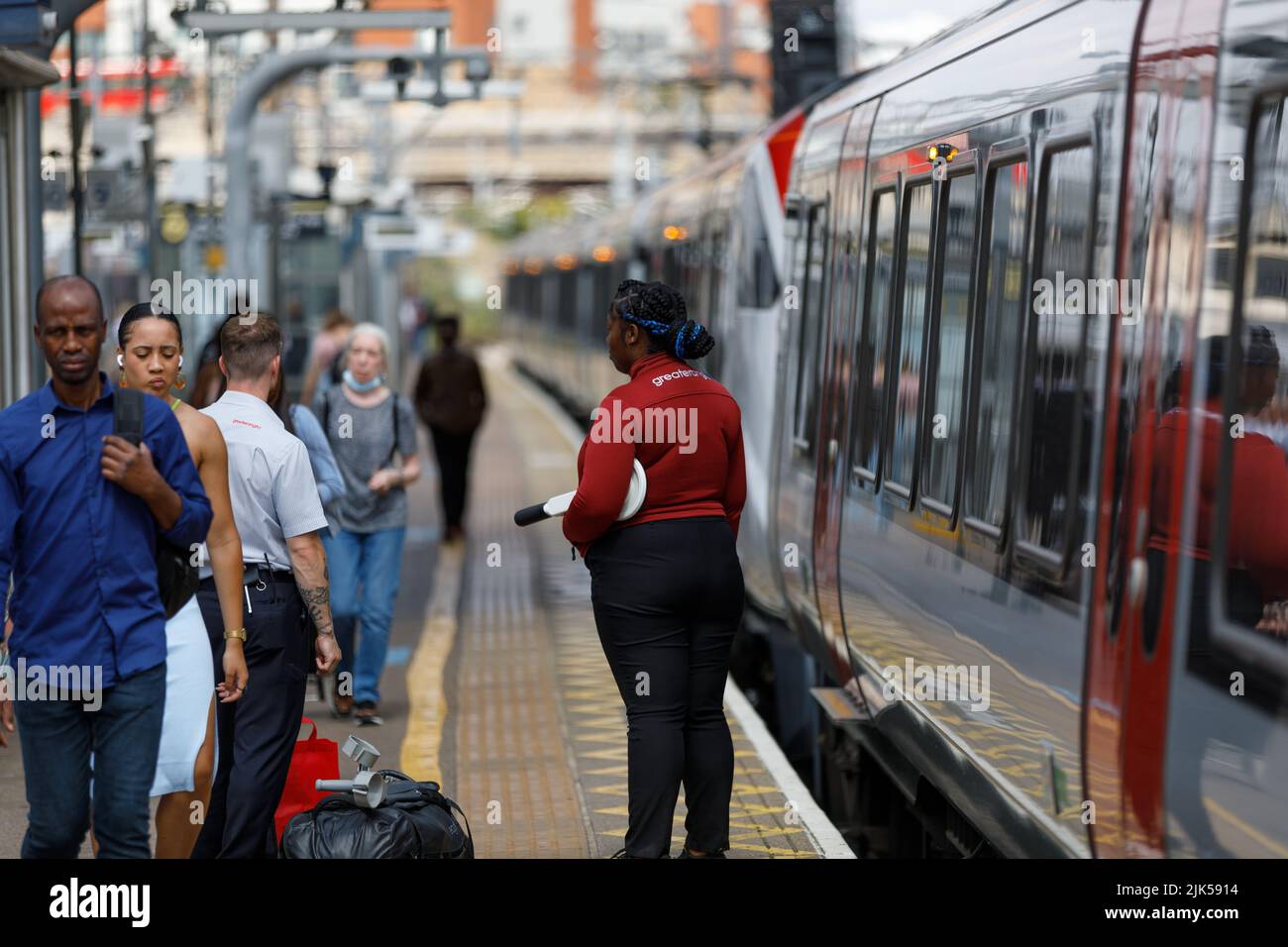 Train disruption after a strike. A railway employee and passengers on ...