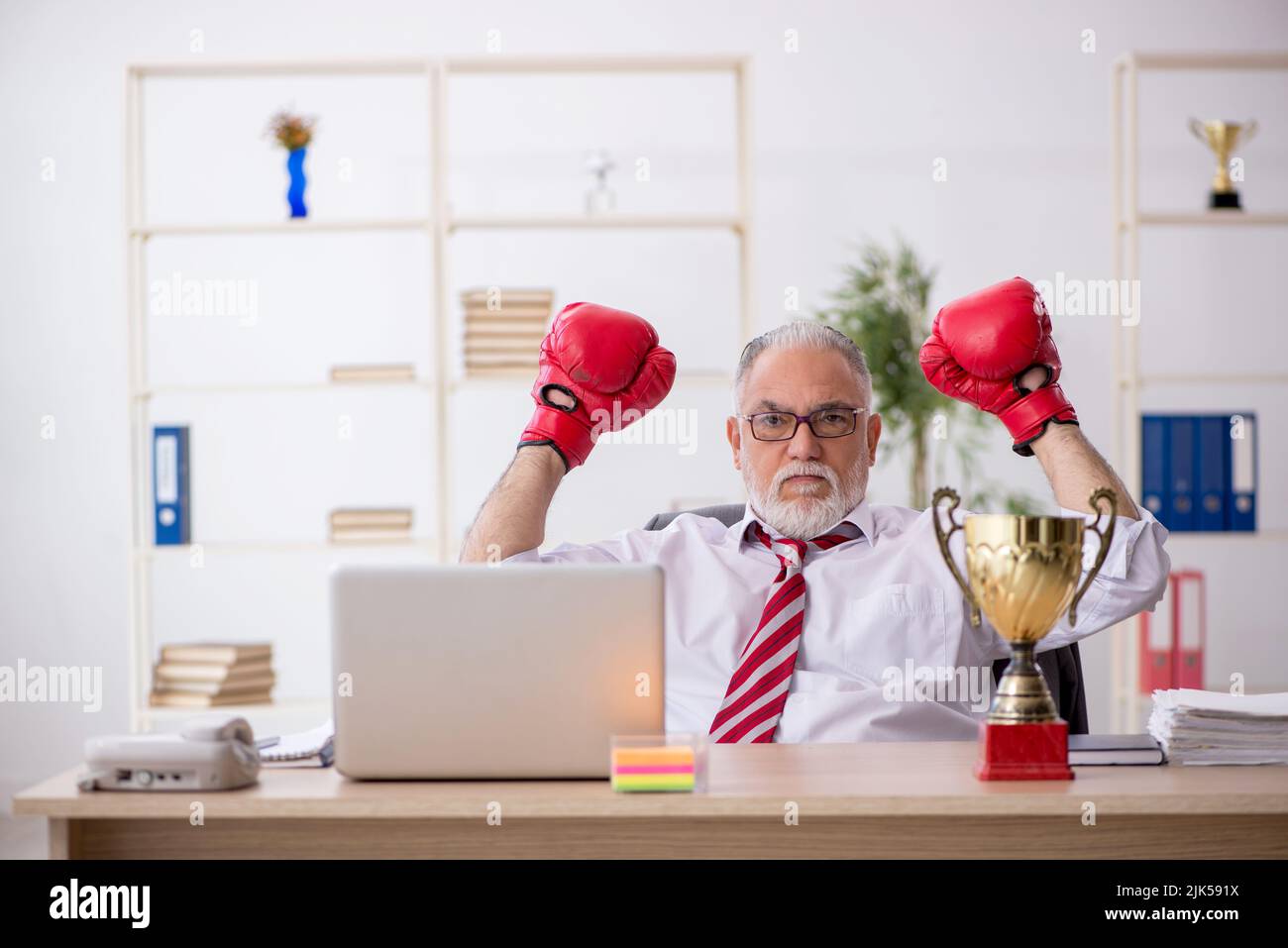 Old businessman employee boxer being awarded with golden cup Stock ...