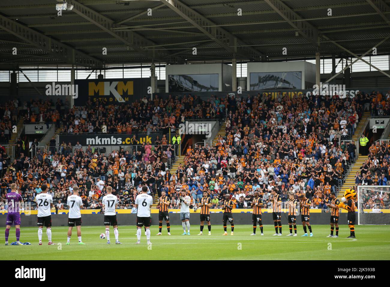 Players observe a minutes applause for the passing of Terry Neil Stock ...