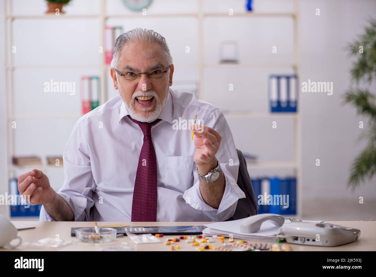 Old man sniffing drugs hi-res stock photography and images - Alamy