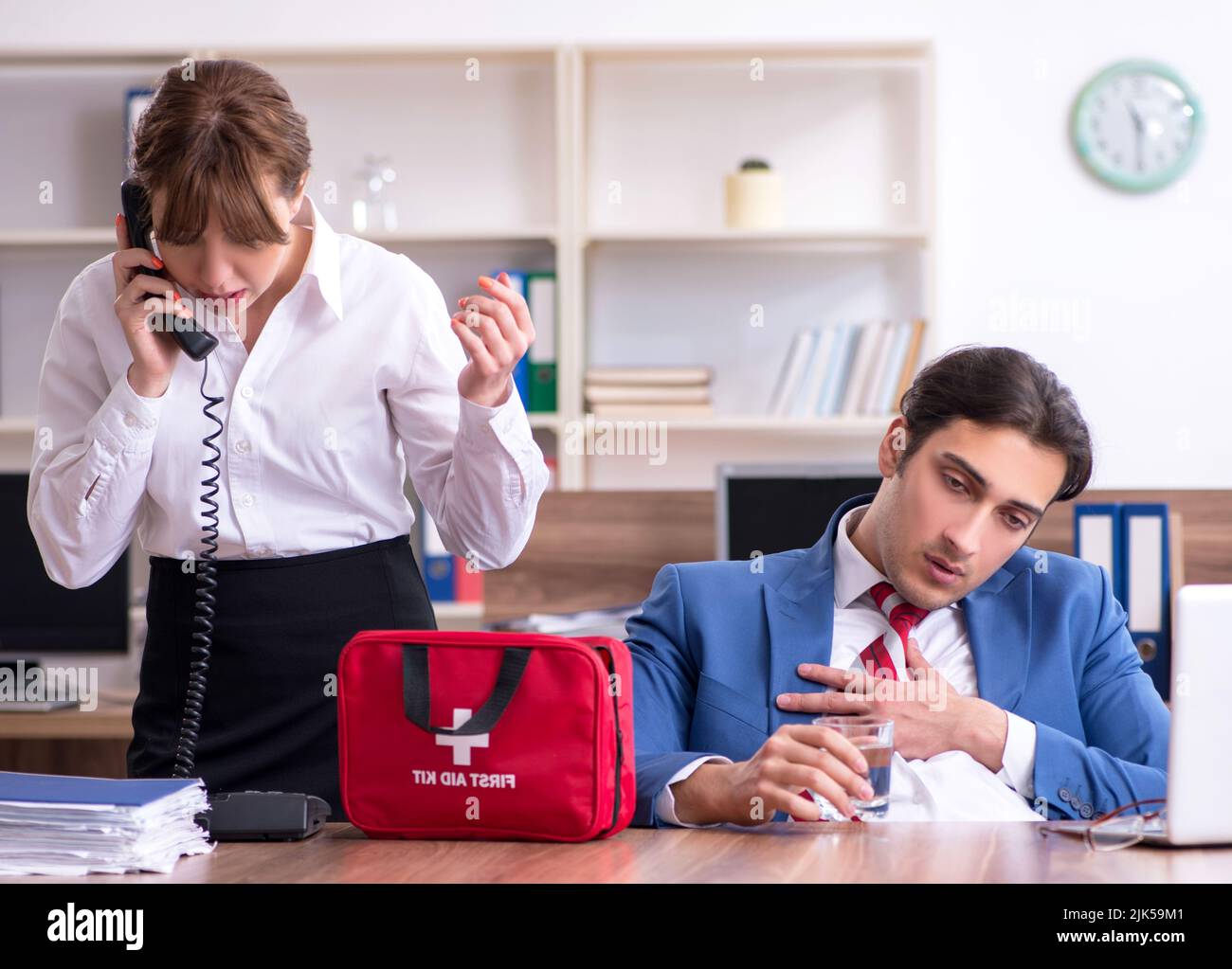 Employee receiving first aid in office Stock Photo - Alamy