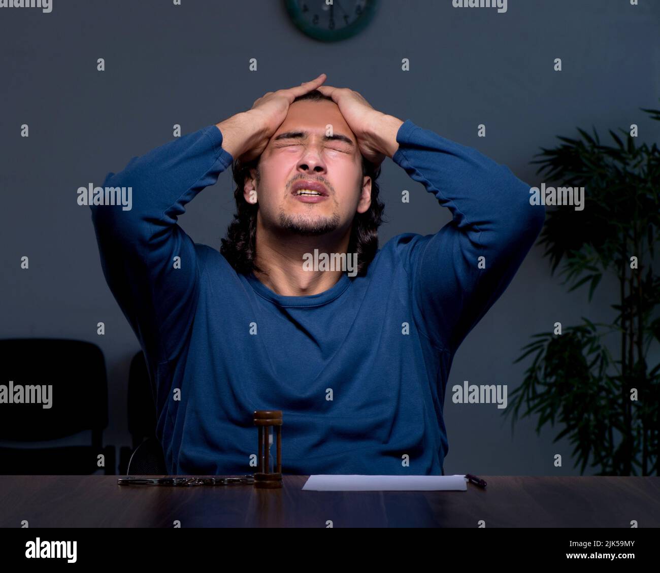 The young convict man sitting in dark room Stock Photo - Alamy