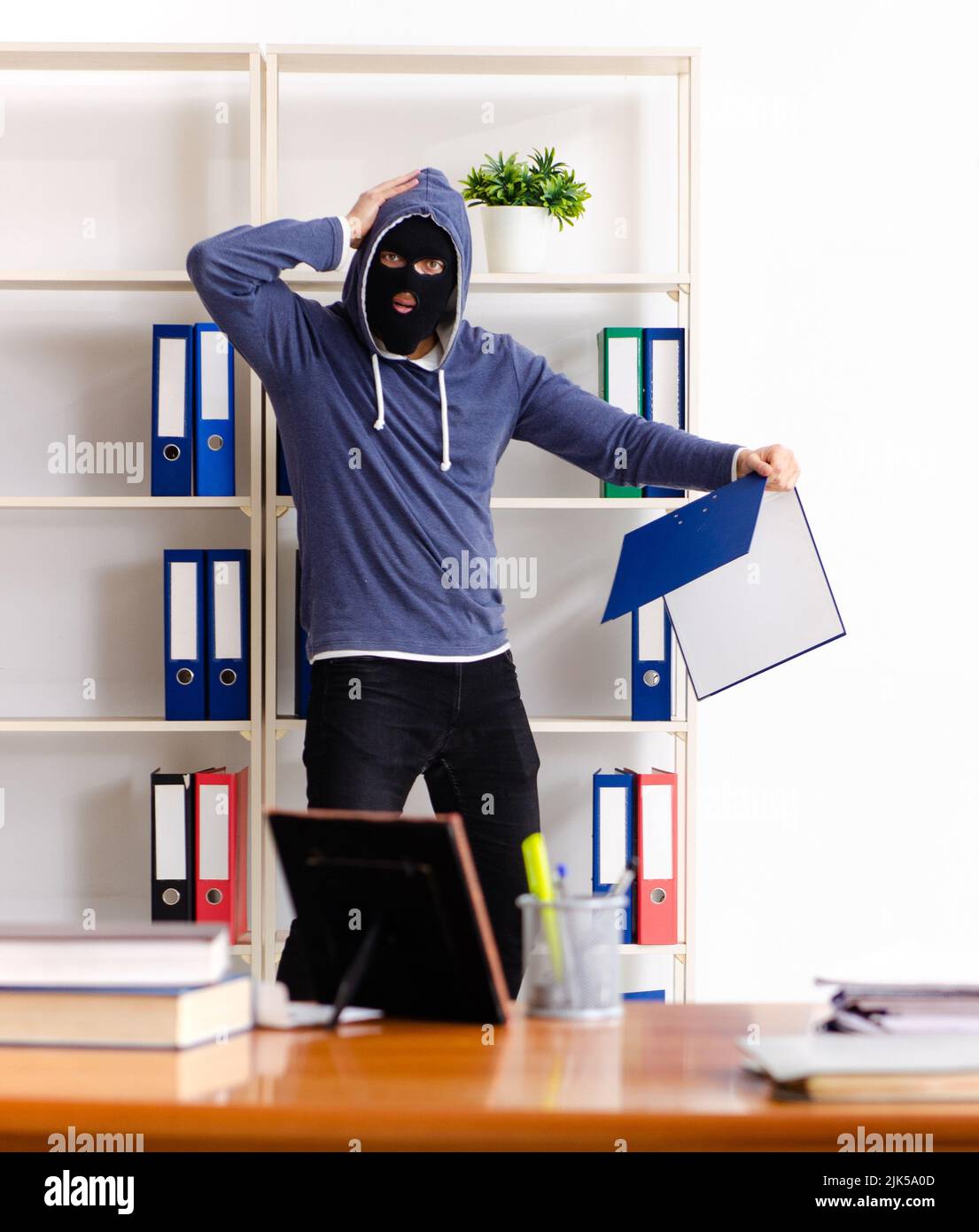 The male thief in balaclava in the office Stock Photo - Alamy