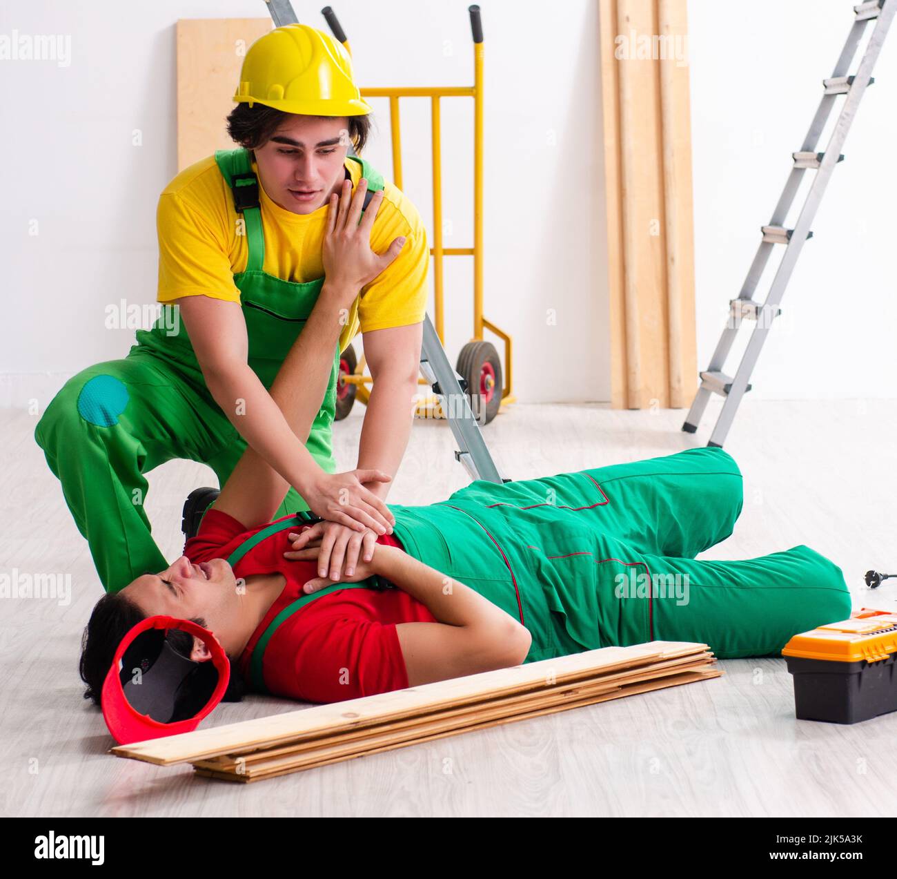The injured worker and his workmate Stock Photo - Alamy