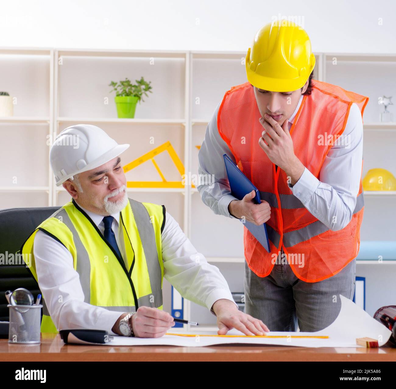 The two engineers colleagues working under project Stock Photo - Alamy