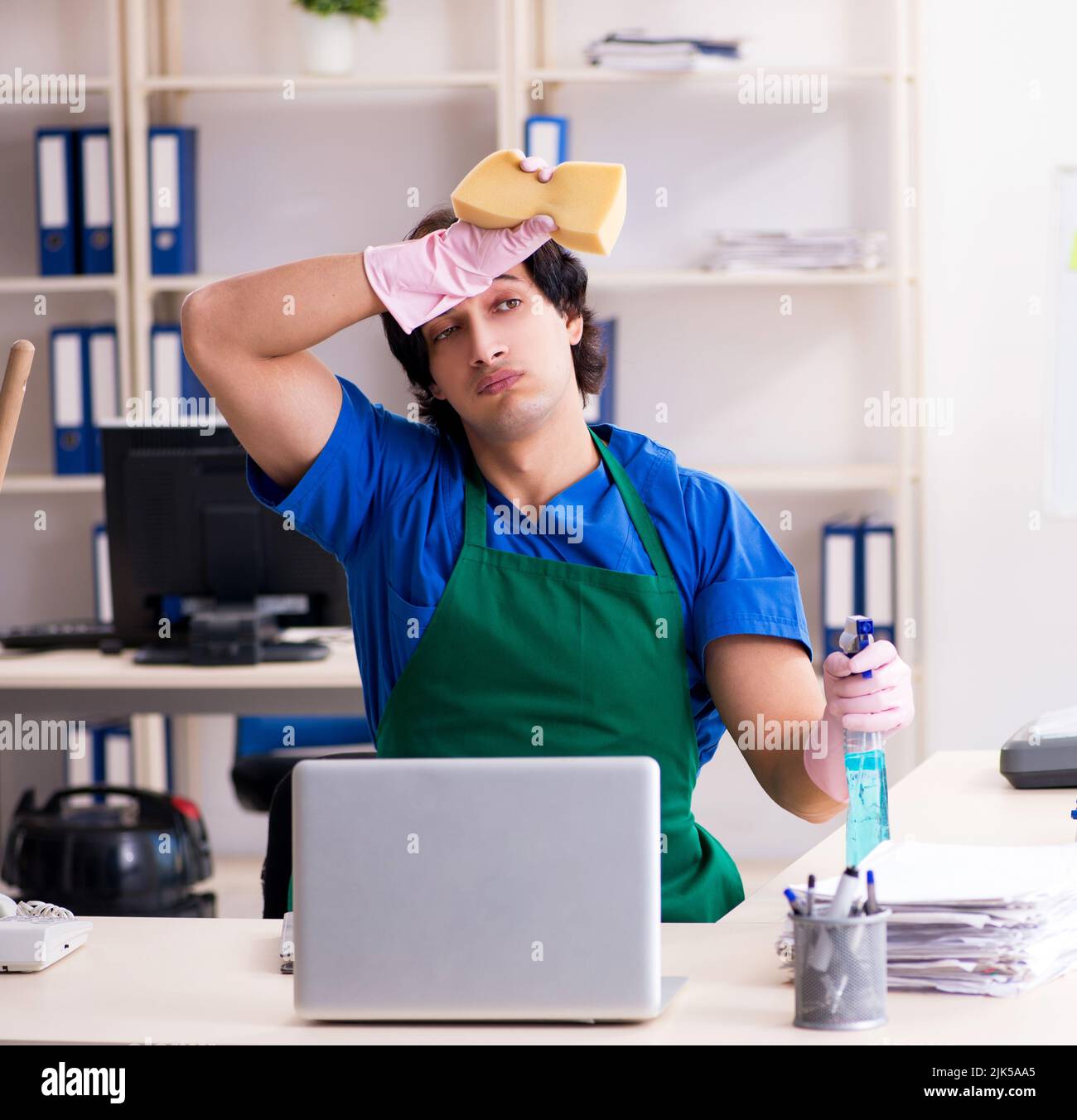 The male handsome professional cleaner working in the office Stock ...