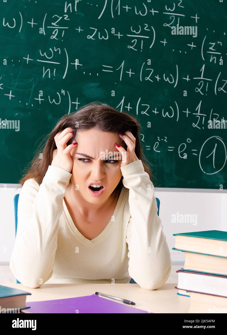 The young female math teacher in front of chalkboard Stock Photo - Alamy