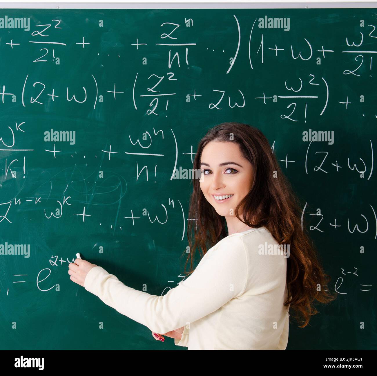The young female math teacher in front of chalkboard Stock Photo - Alamy