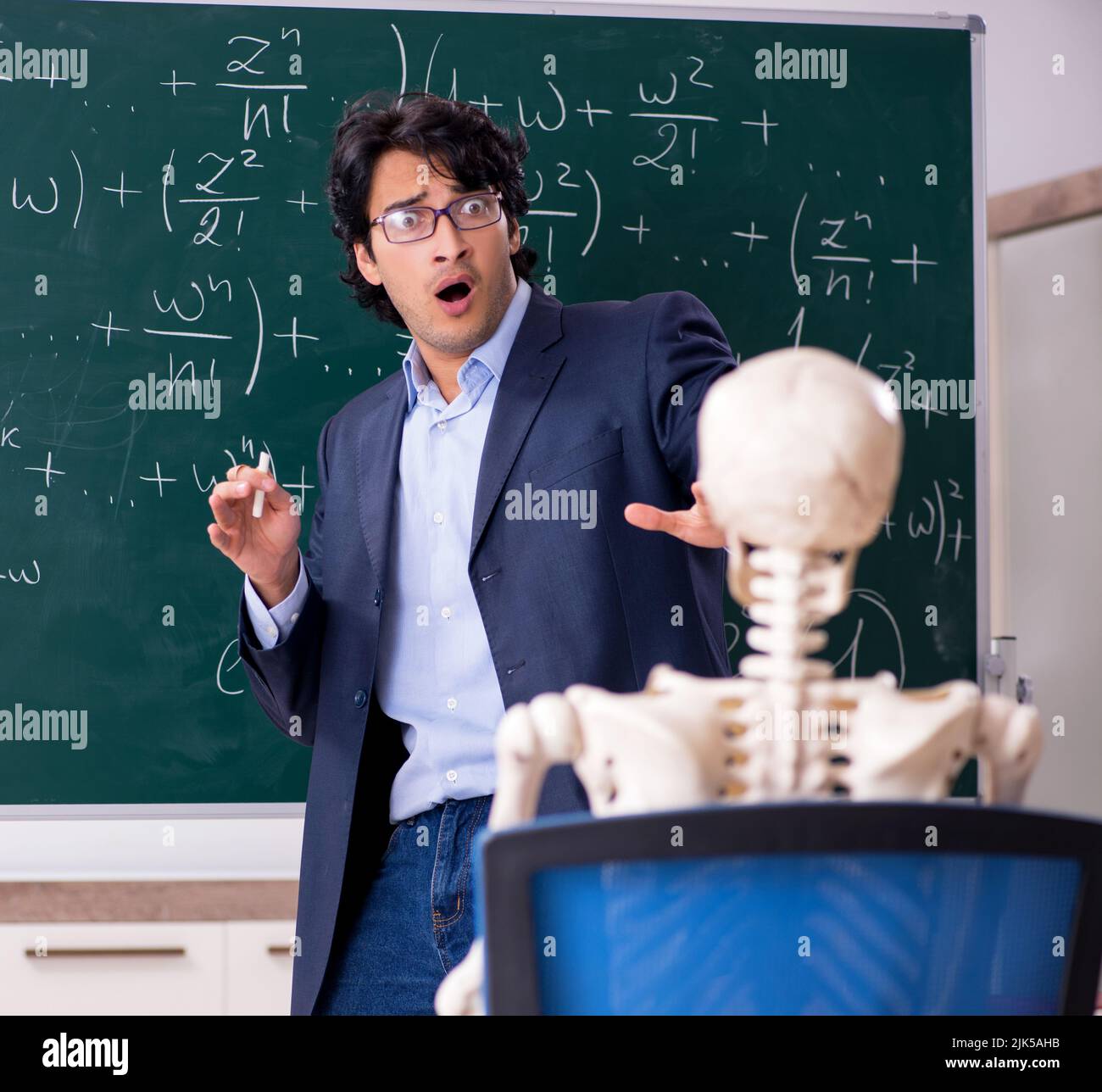 The young male math teacher and student skeleton Stock Photo - Alamy