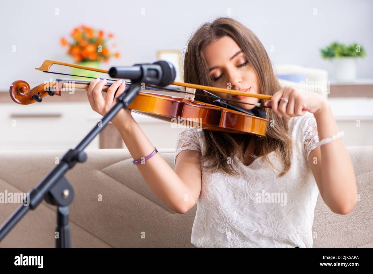 The female beautiful musician playing violin at home Stock Photo - Alamy