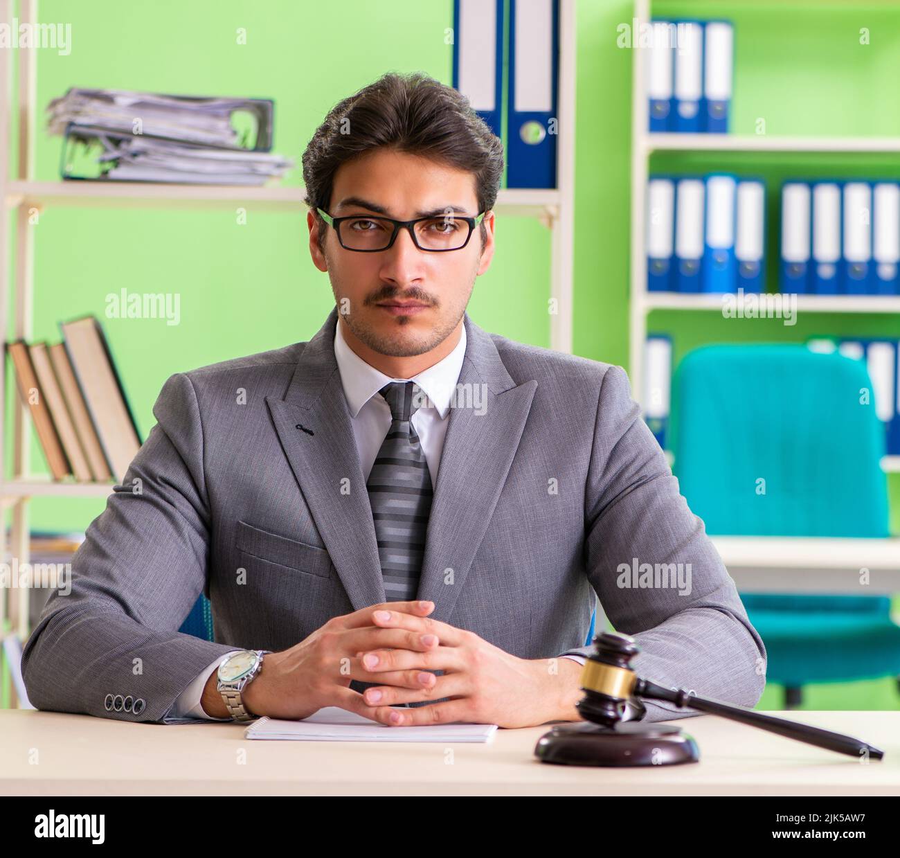 The young handsome lawyer working in the office Stock Photo - Alamy
