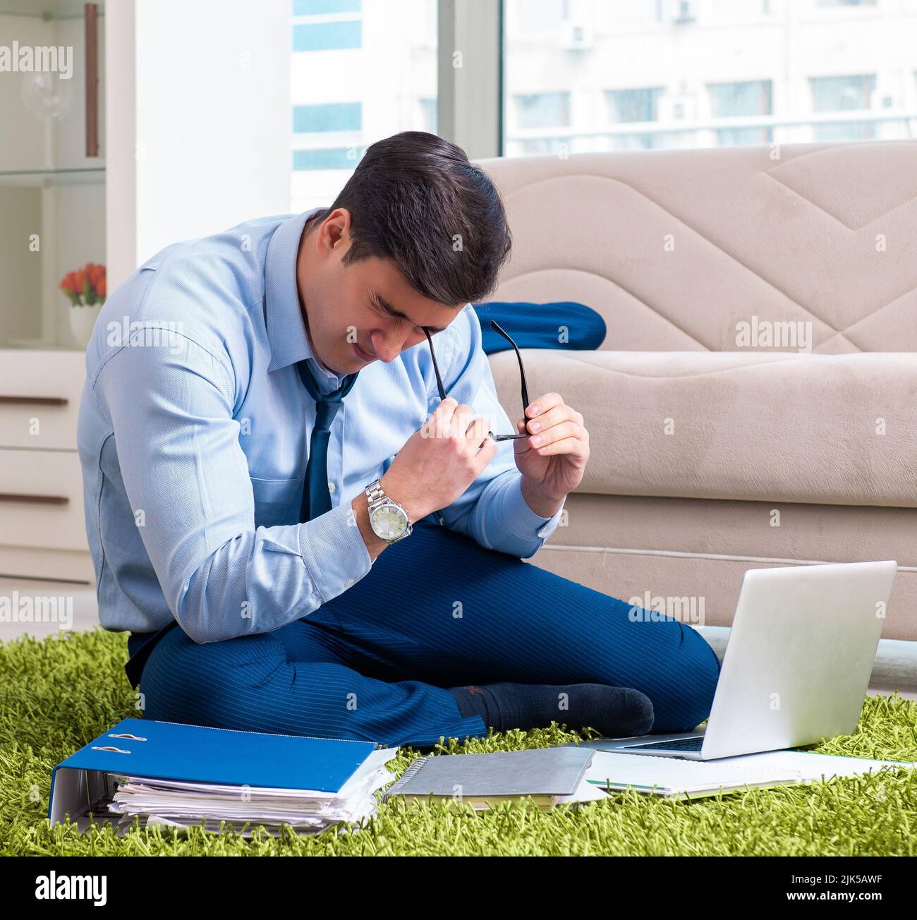The businessman taking work home and working overtime Stock Photo - Alamy