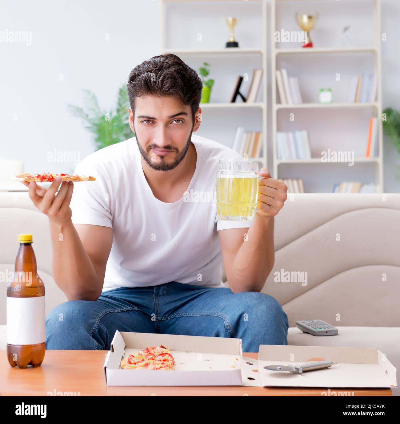 The man eating pizza having a takeaway at home relaxing resting Stock ...