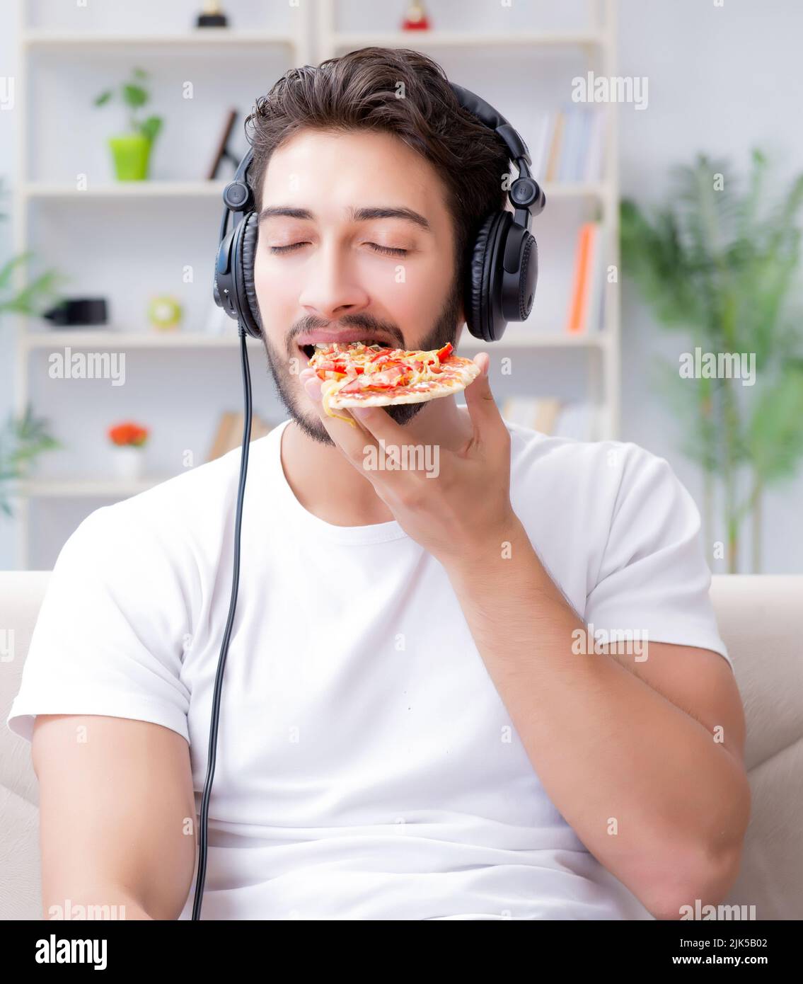 The man eating pizza having a takeaway at home relaxing resting Stock ...