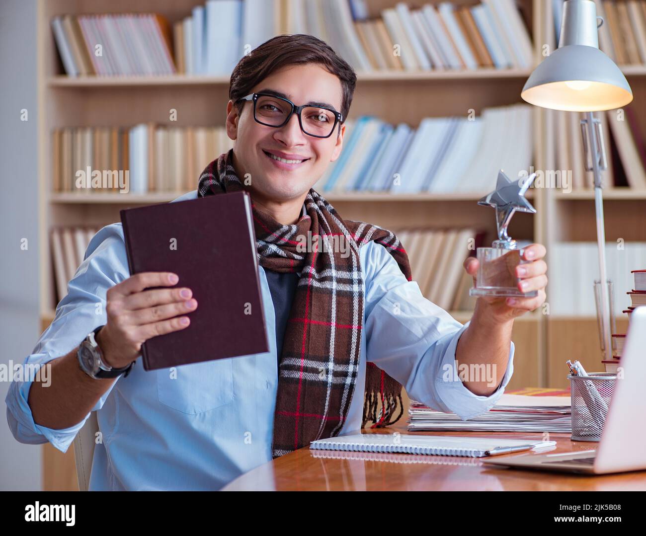The young book writer writing in library Stock Photo - Alamy