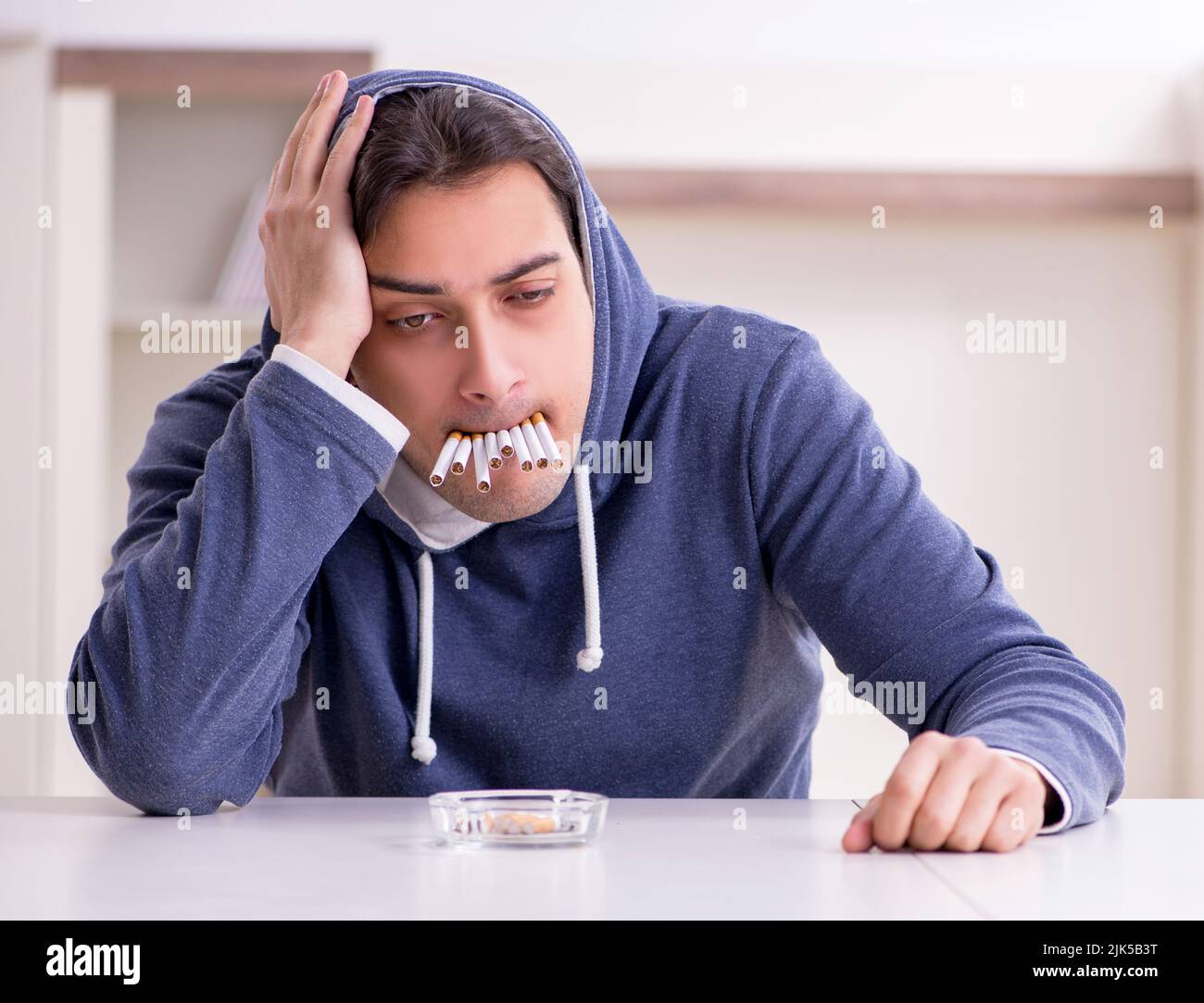 The young man having problems with narcotics at home Stock Photo - Alamy