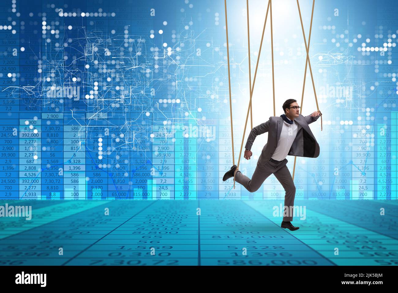 Businessman puppet being manipulated by the ropes Stock Photo - Alamy