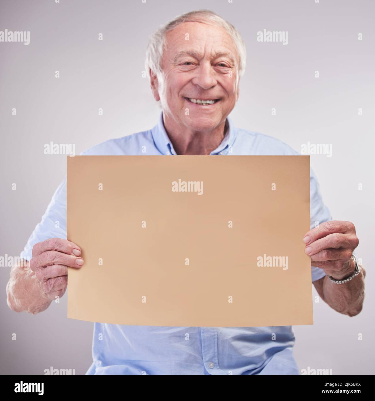 Hey everybody, look what I have. Studio shot of a senior man holding a ...