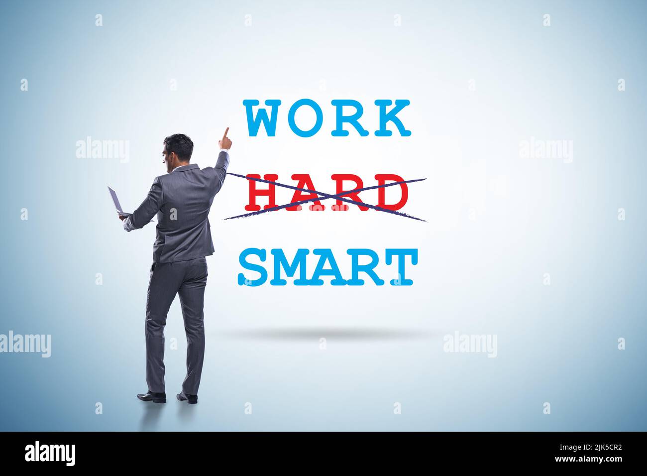 Businessman in the working smart not hard concept Stock Photo - Alamy