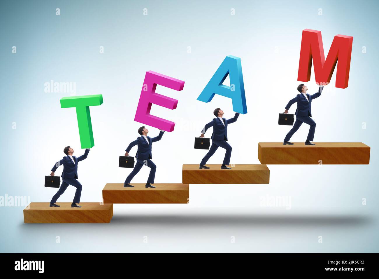 Teamwork concept with the people carrying team letters Stock Photo - Alamy