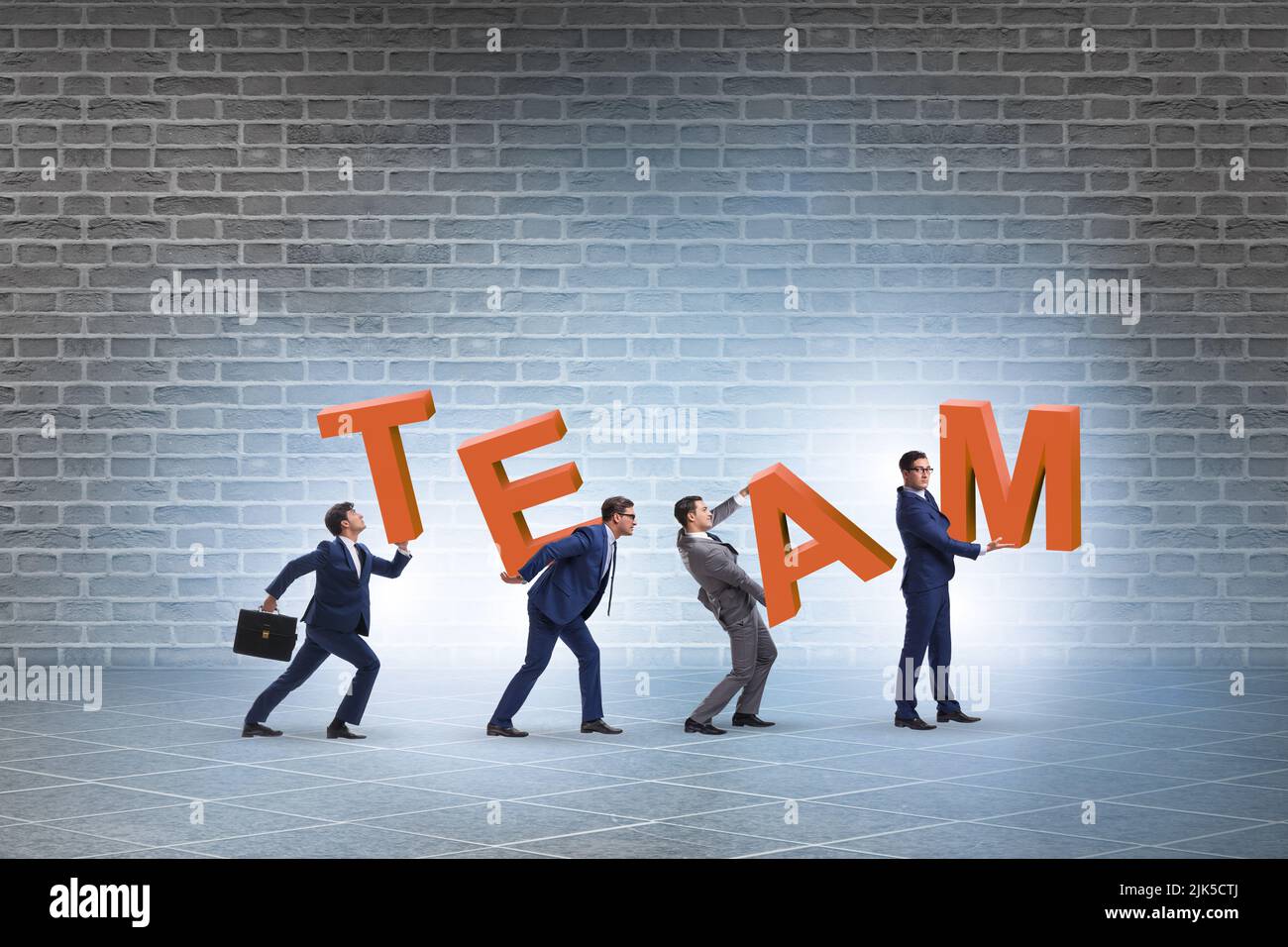 Teamwork concept with the people carrying team letters Stock Photo - Alamy