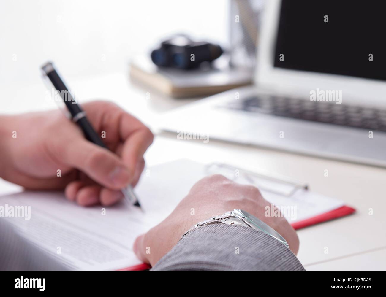 The businessman taking notes at the meeting Stock Photo - Alamy