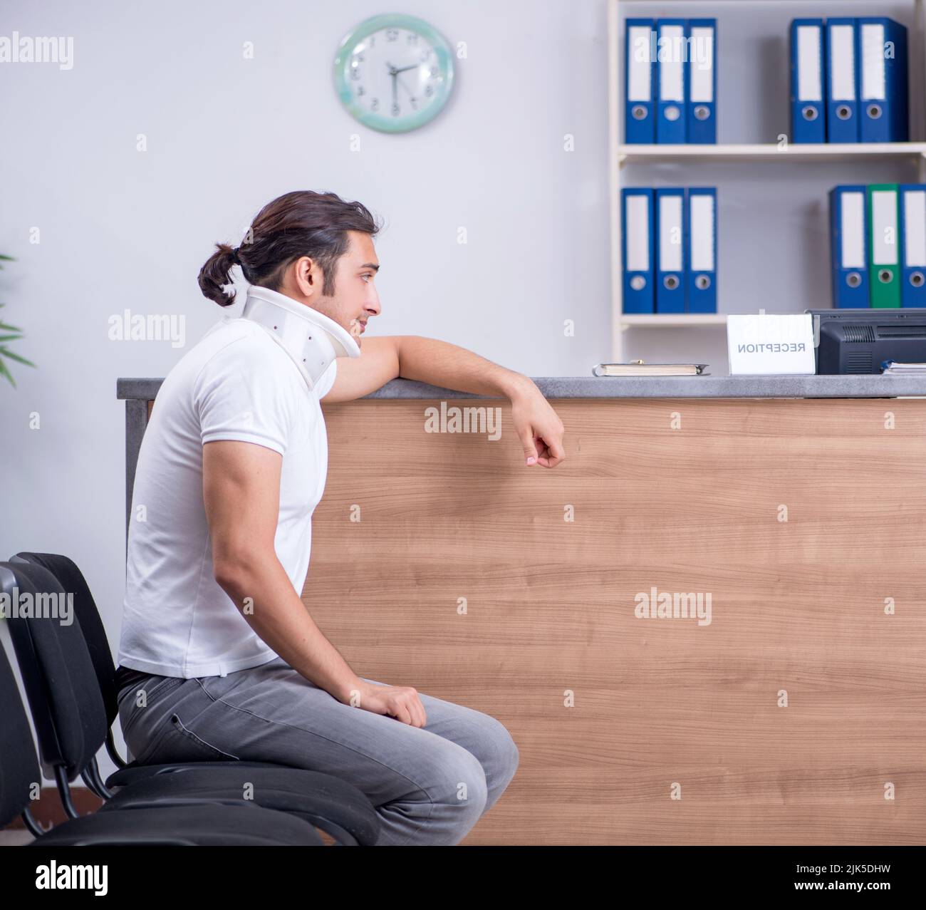 Clinic reception counter and young patient Stock Photo - Alamy