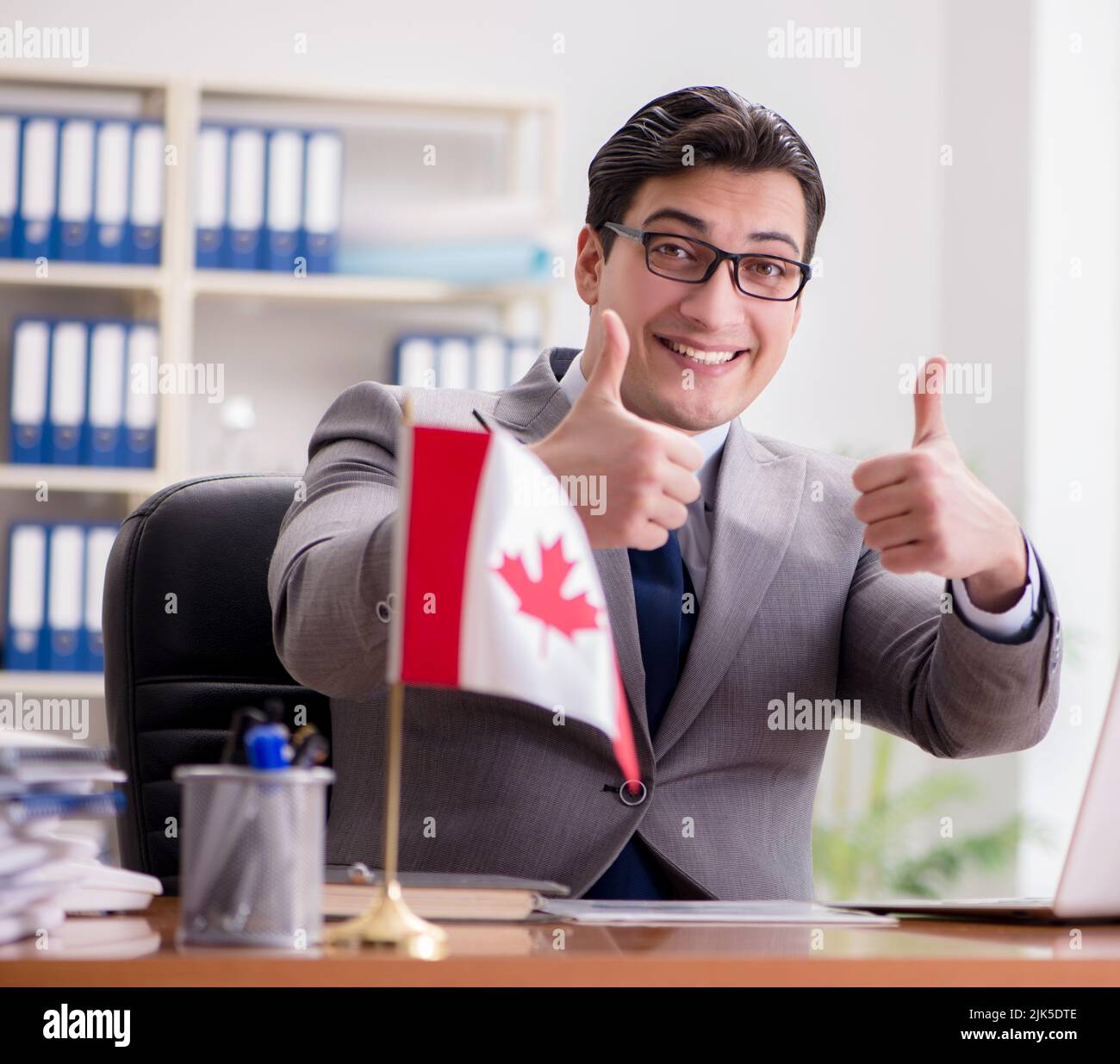 The businessman with canadian flag in office Stock Photo - Alamy