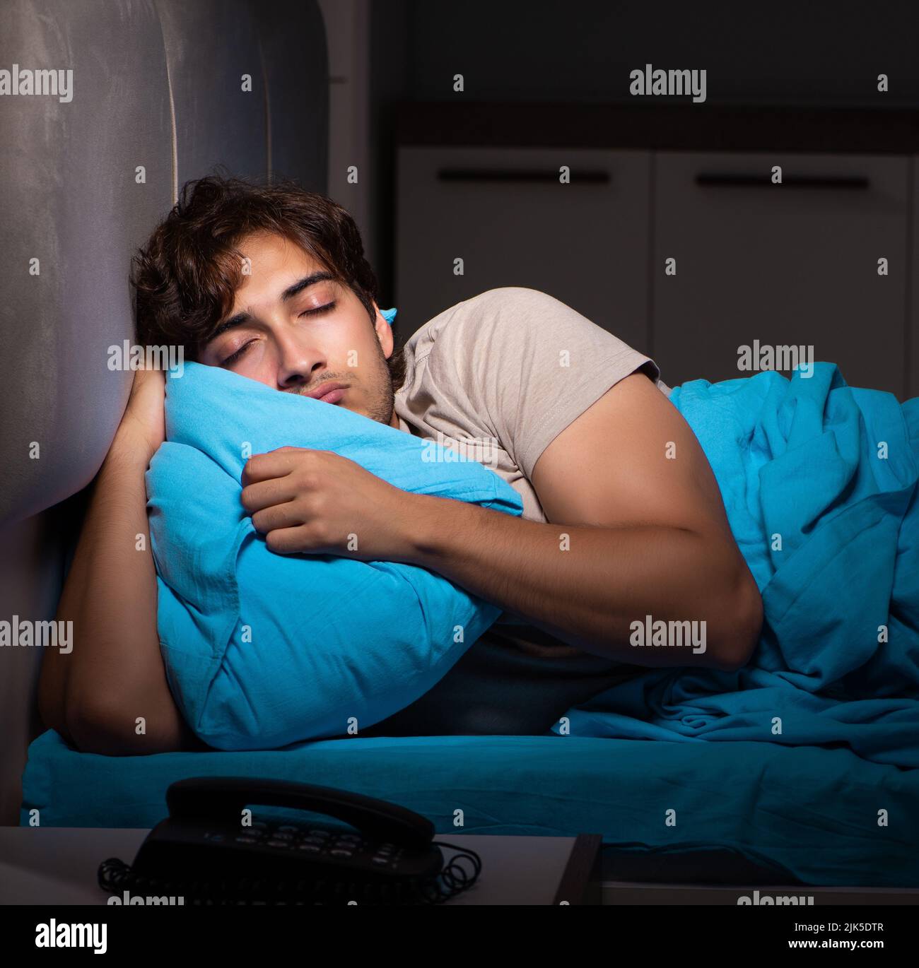 Tired exhausted man sleeping in his bed Stock Photo - Alamy