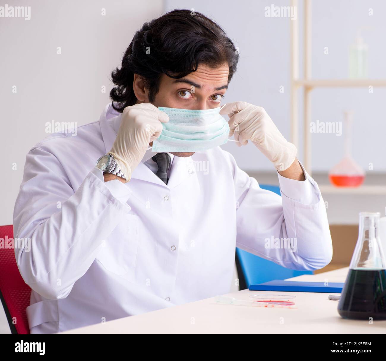 Handsome scientist looking beaker hi-res stock photography and images ...
