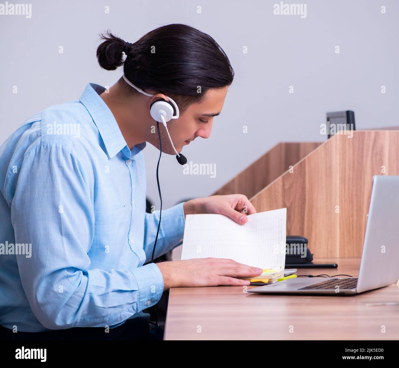 The call center operator working at his desk Stock Photo - Alamy