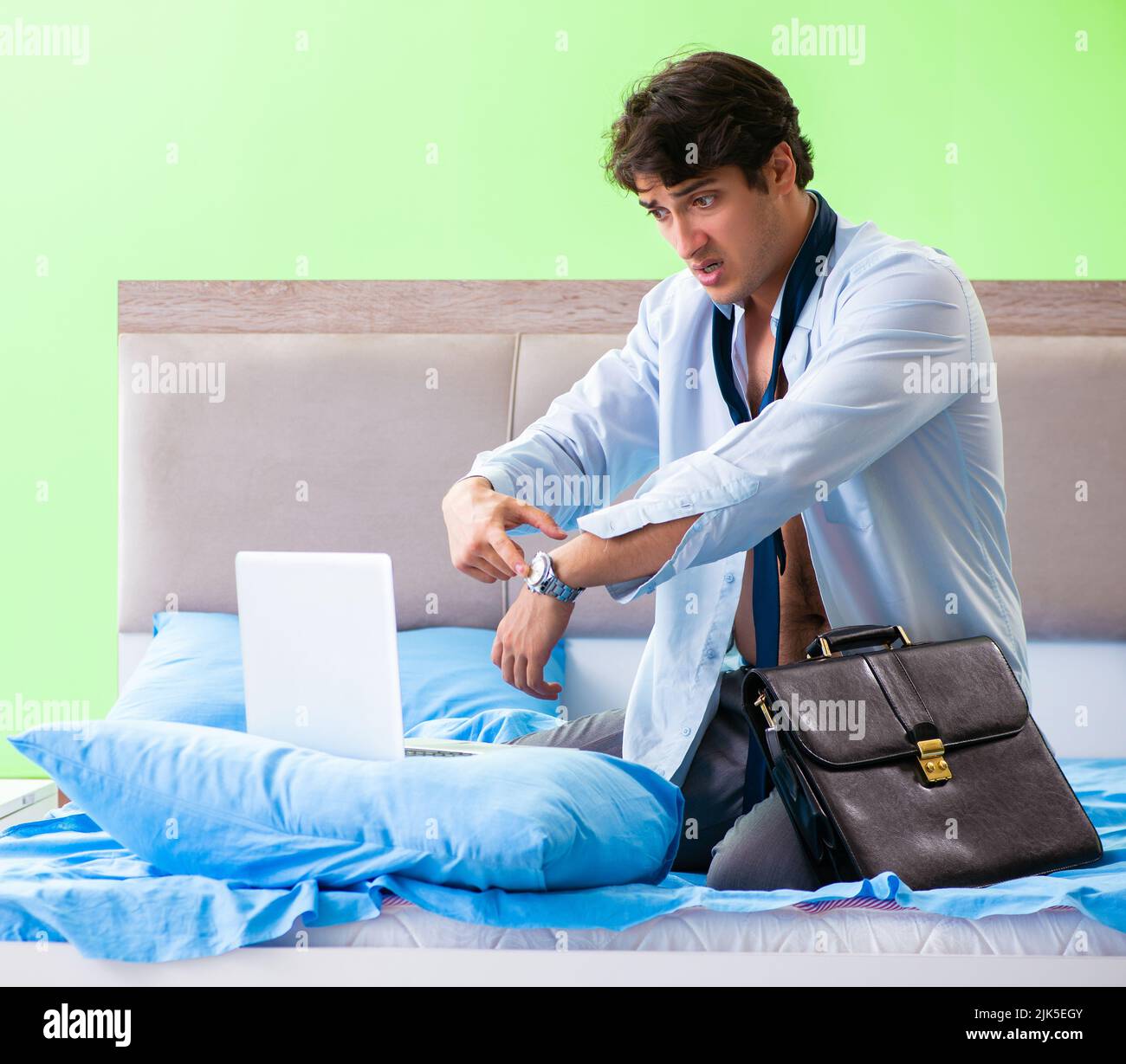 Employee in the bedroom being late for his job in time management ...
