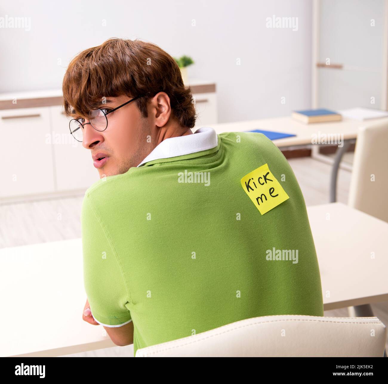 Office prank with kick me message on sticky note Stock Photo - Alamy