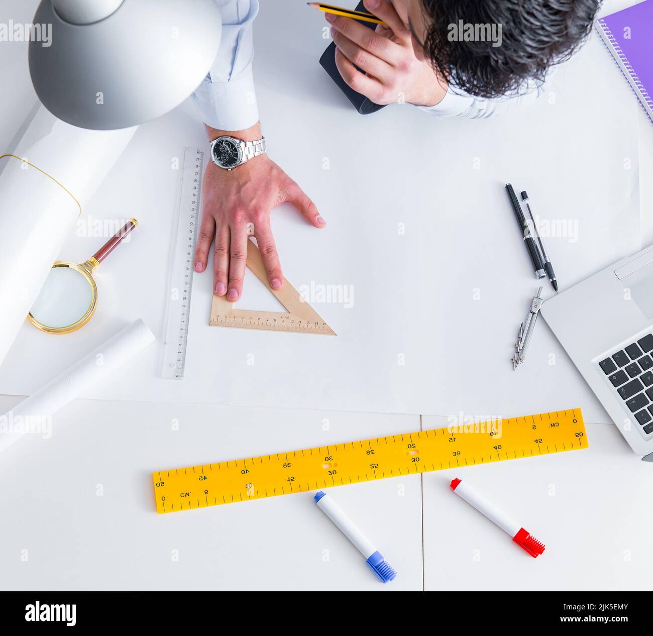 The engineer working on new project drawings Stock Photo - Alamy