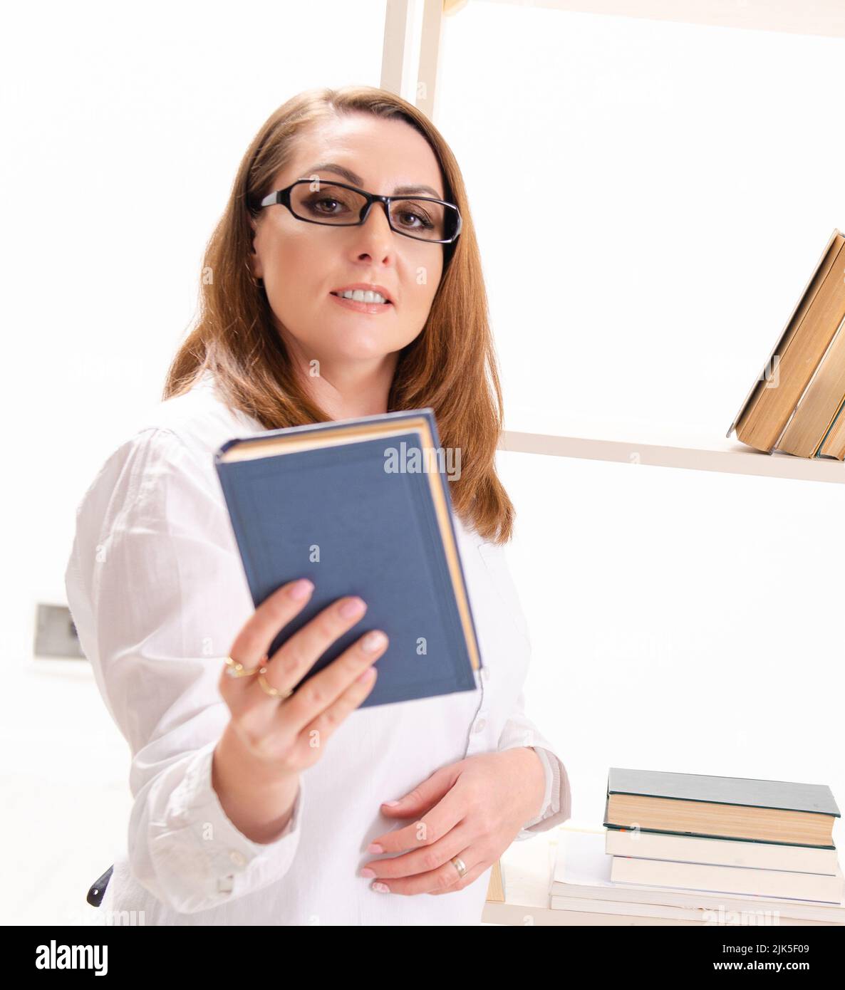 Female math teacher in the classroom Stock Photo - Alamy