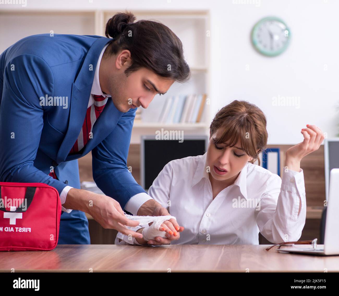 Employee receiving first aid in office Stock Photo - Alamy