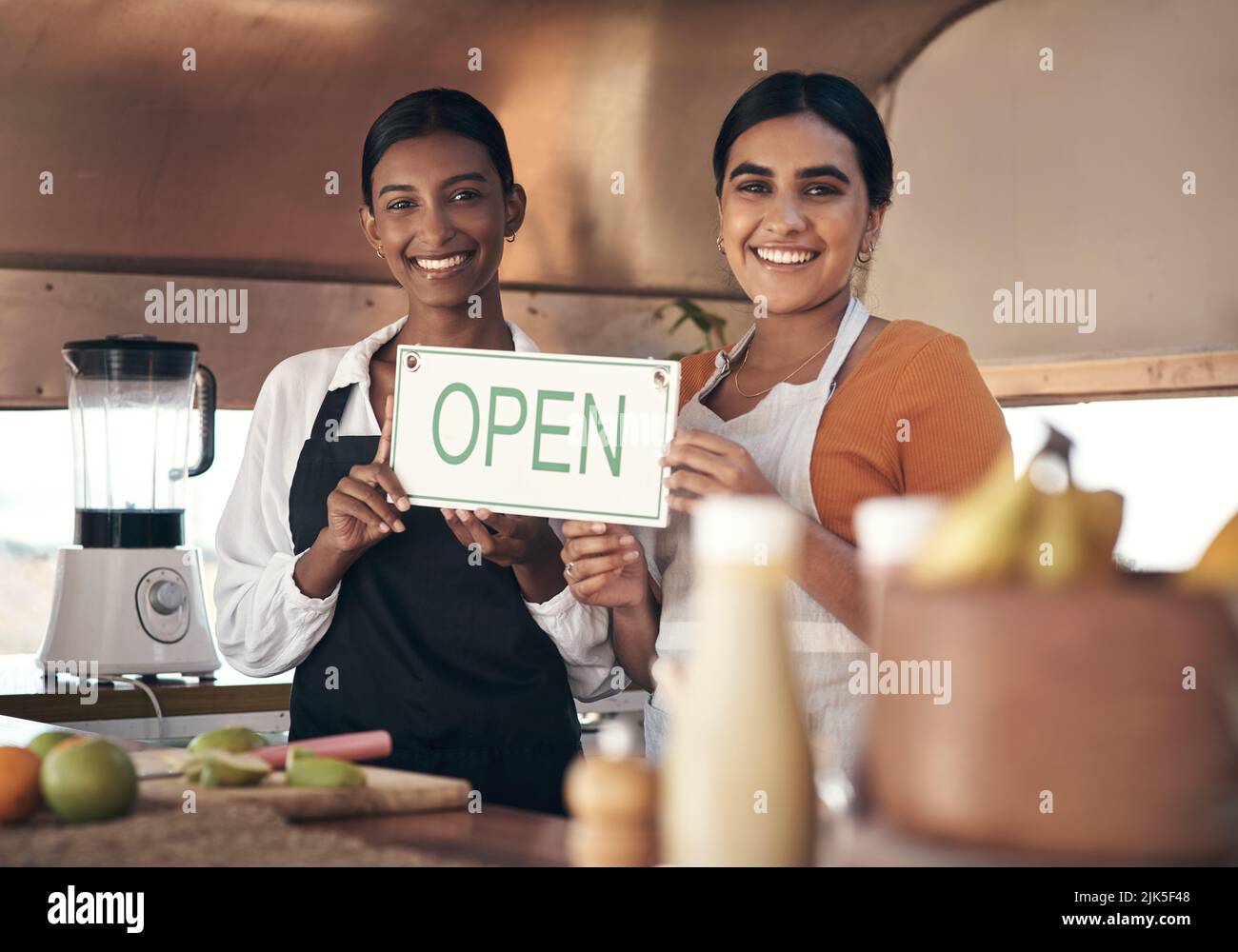 Sisters doing it for themselves. two young businesswomen holding an ...