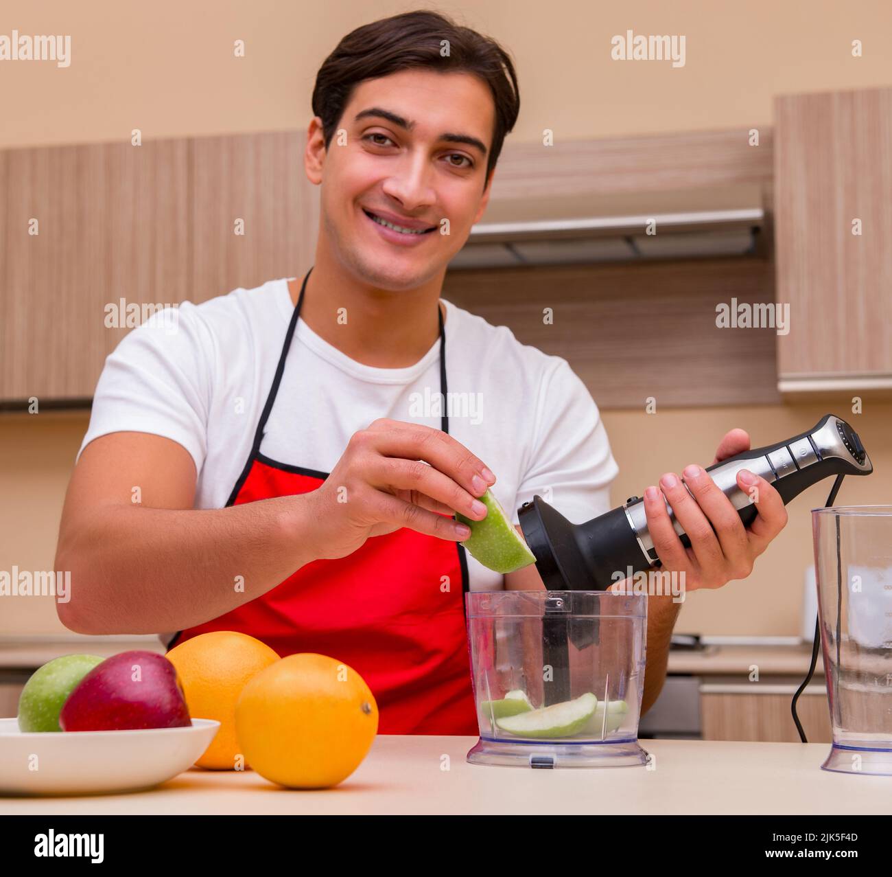 The handsome man working at the kitchen Stock Photo - Alamy