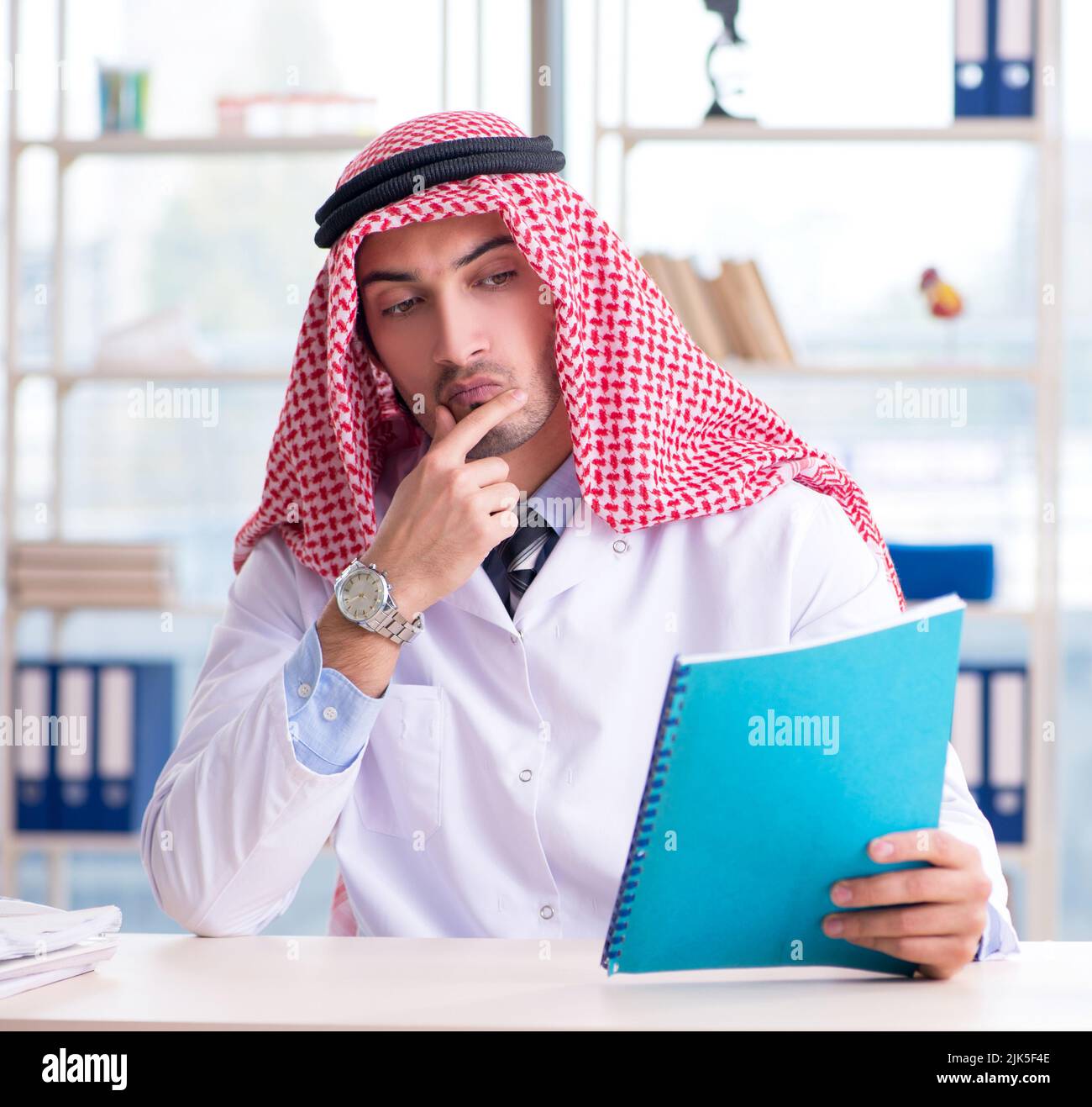 Arab doctor man reading hi-res stock photography and images - Alamy