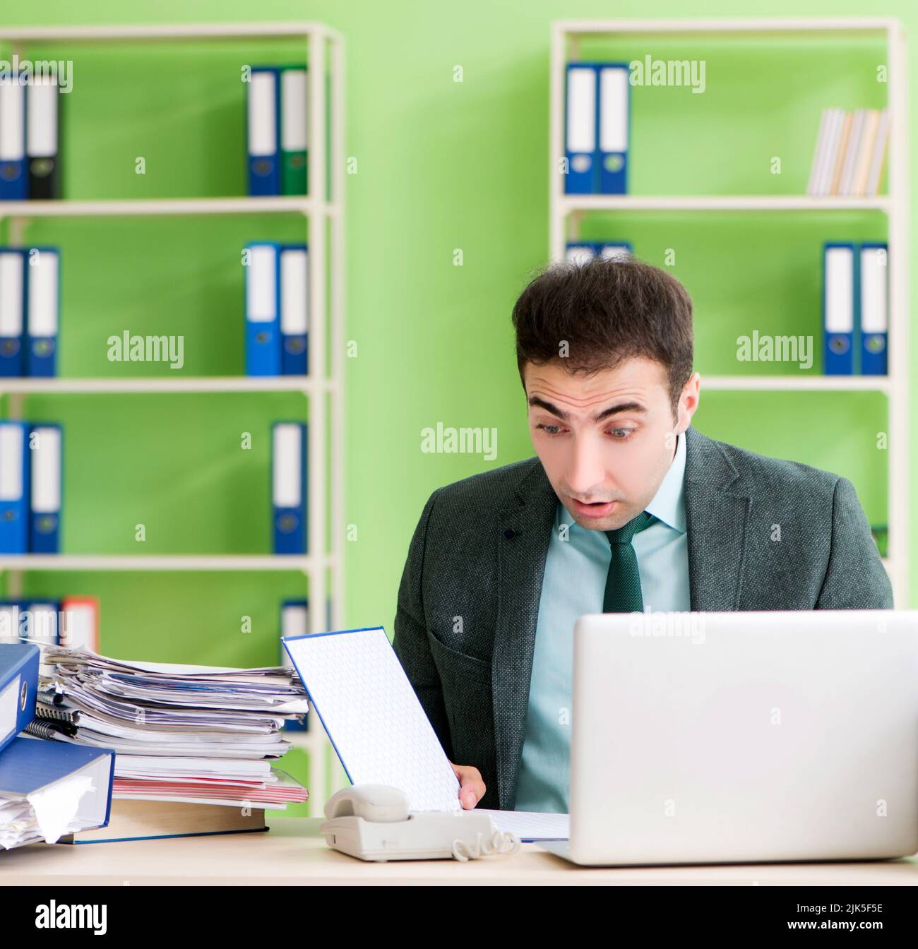 The businessman angry with excessive work sitting in the office Stock ...