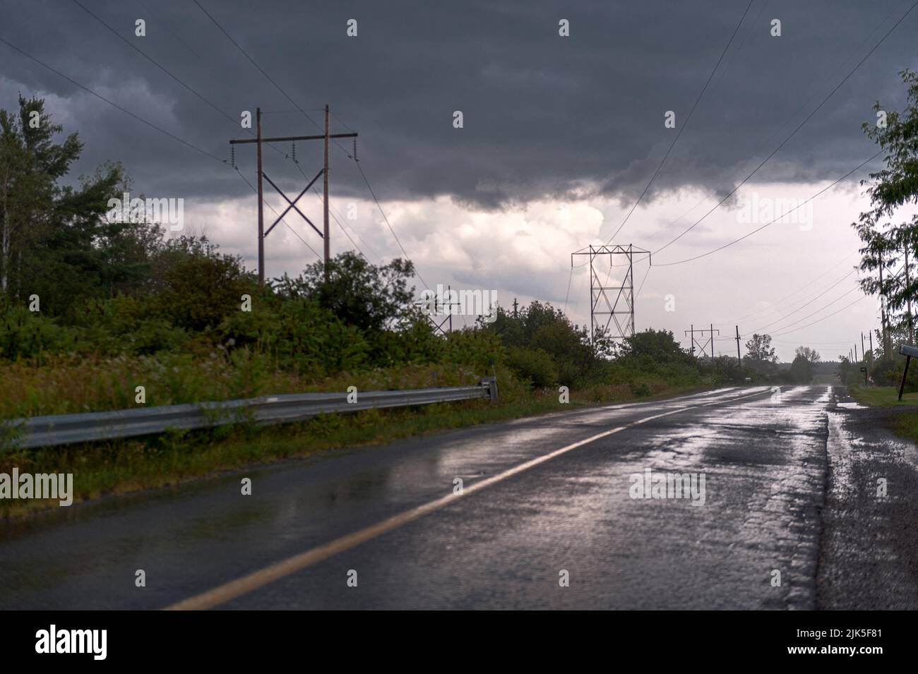 storm clouds over wet country road Stock Photo - Alamy