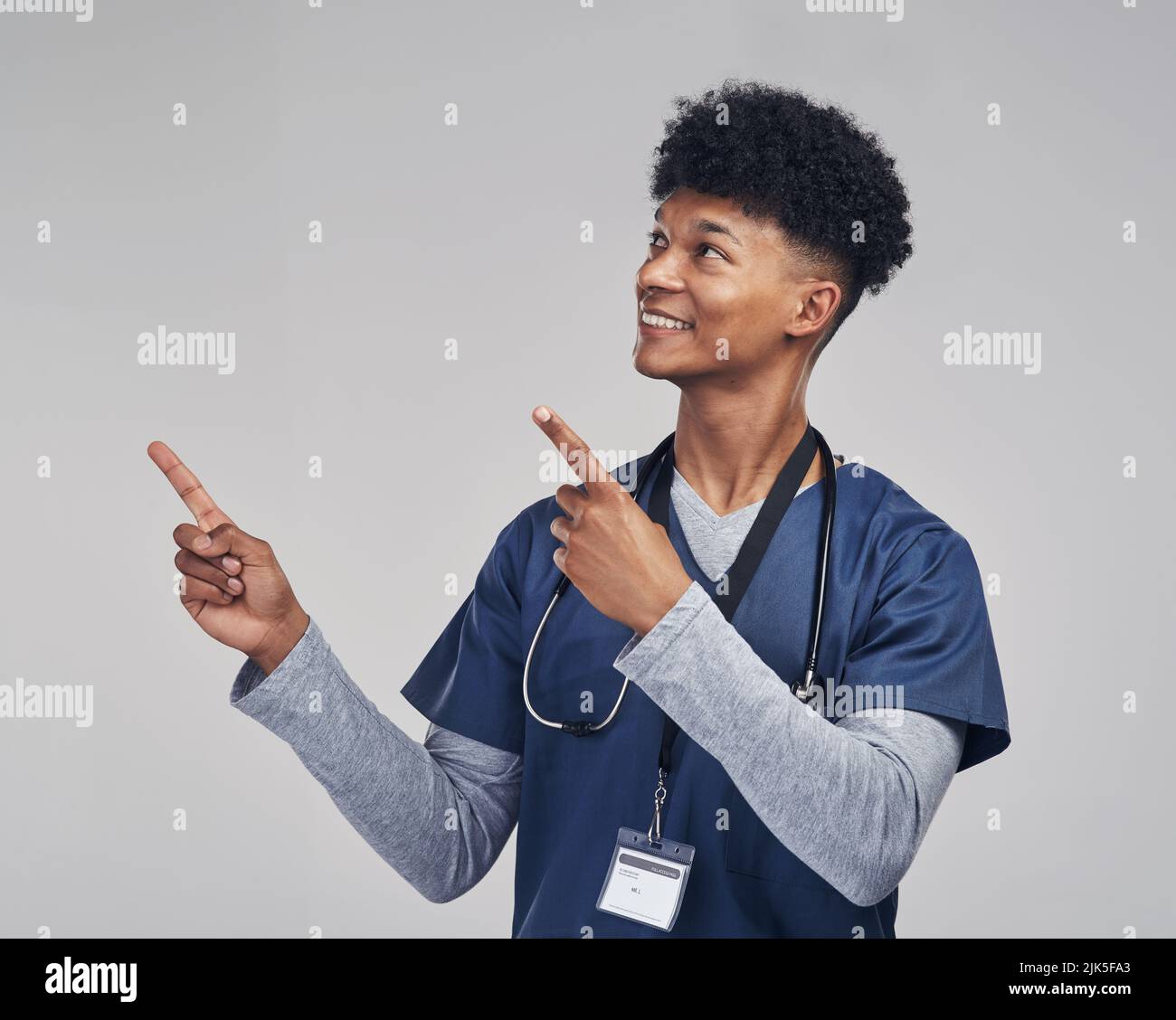 This one comes highly recommended. a male nurse pointing at copy space ...