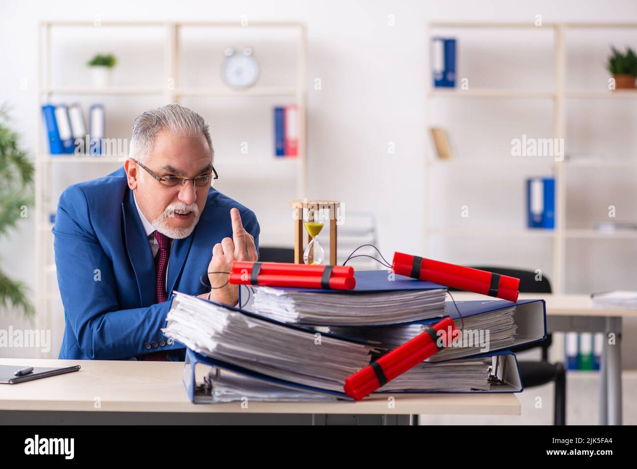 Old busynessman employee with dynamite in the office Stock Photo - Alamy