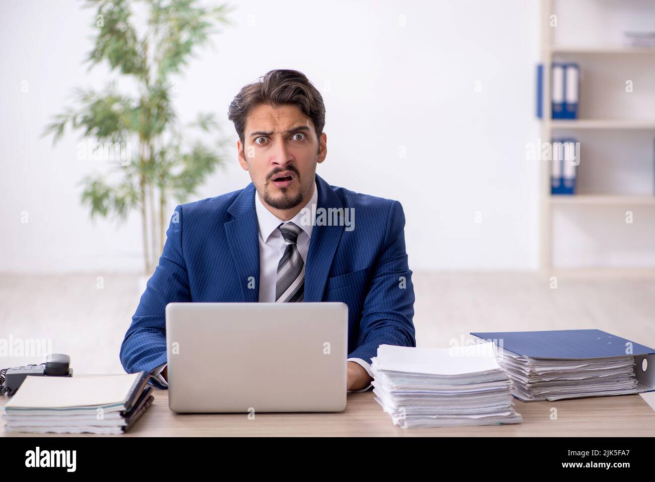 Young businessman employee working at workplace Stock Photo - Alamy